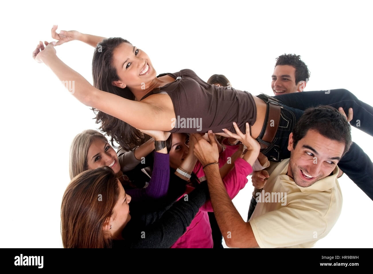Happy group of friends carrying one of the girls - isolated Stock Photo ...