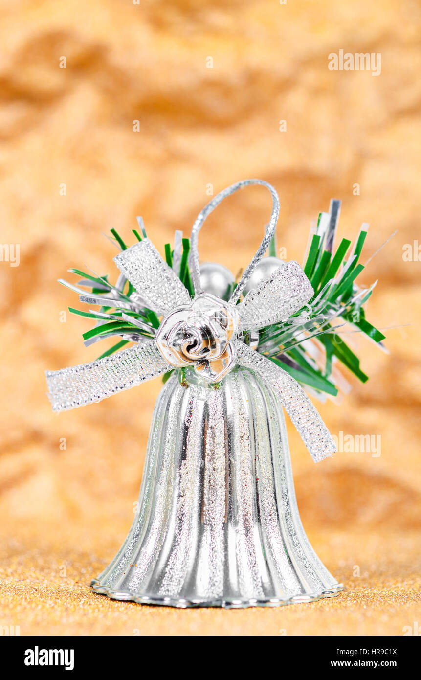 Silver bell decorate for christmas on gold background Stock Photo - Alamy