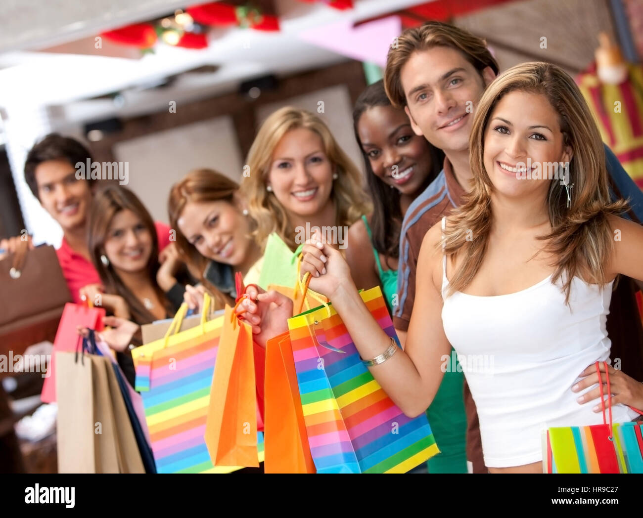 group of shopping people in a mall with some bags Stock Photo - Alamy