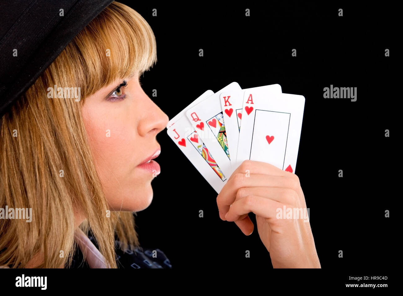Fashion woman showing a royal flush - isolated over a black background ...