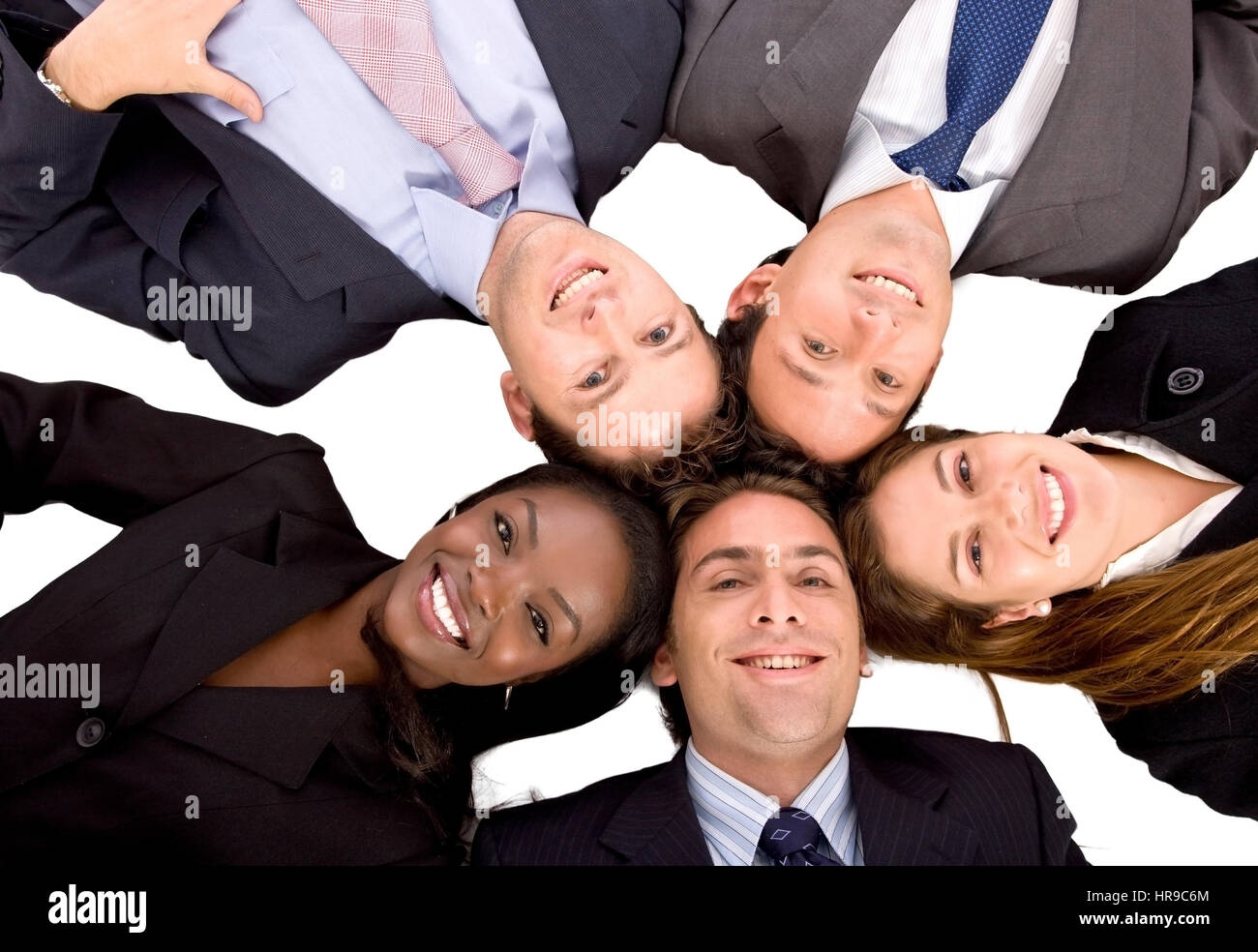 Business team work - heads together over a white background Stock Photo ...