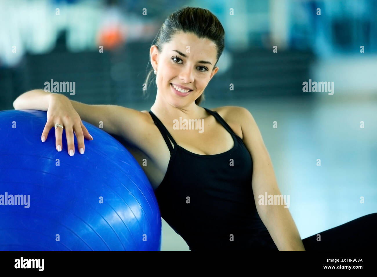 gym woman doing pilates exercises on a blue ball Stock Photo - Alamy