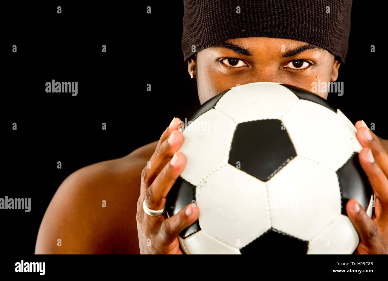 male footballer isolated over a black background Stock Photo - Alamy