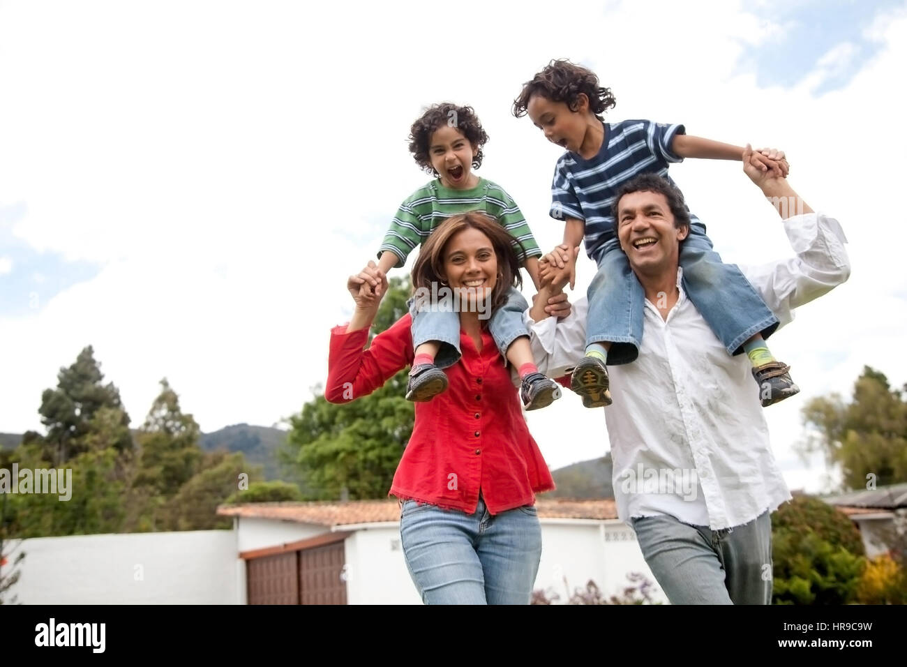 happy family having fun in front of their house Stock Photo - Alamy