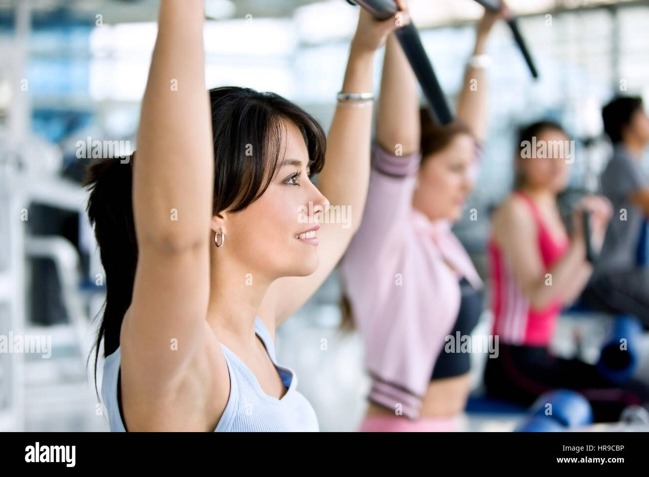 Gym people exercising on weight machines Stock Photo - Alamy