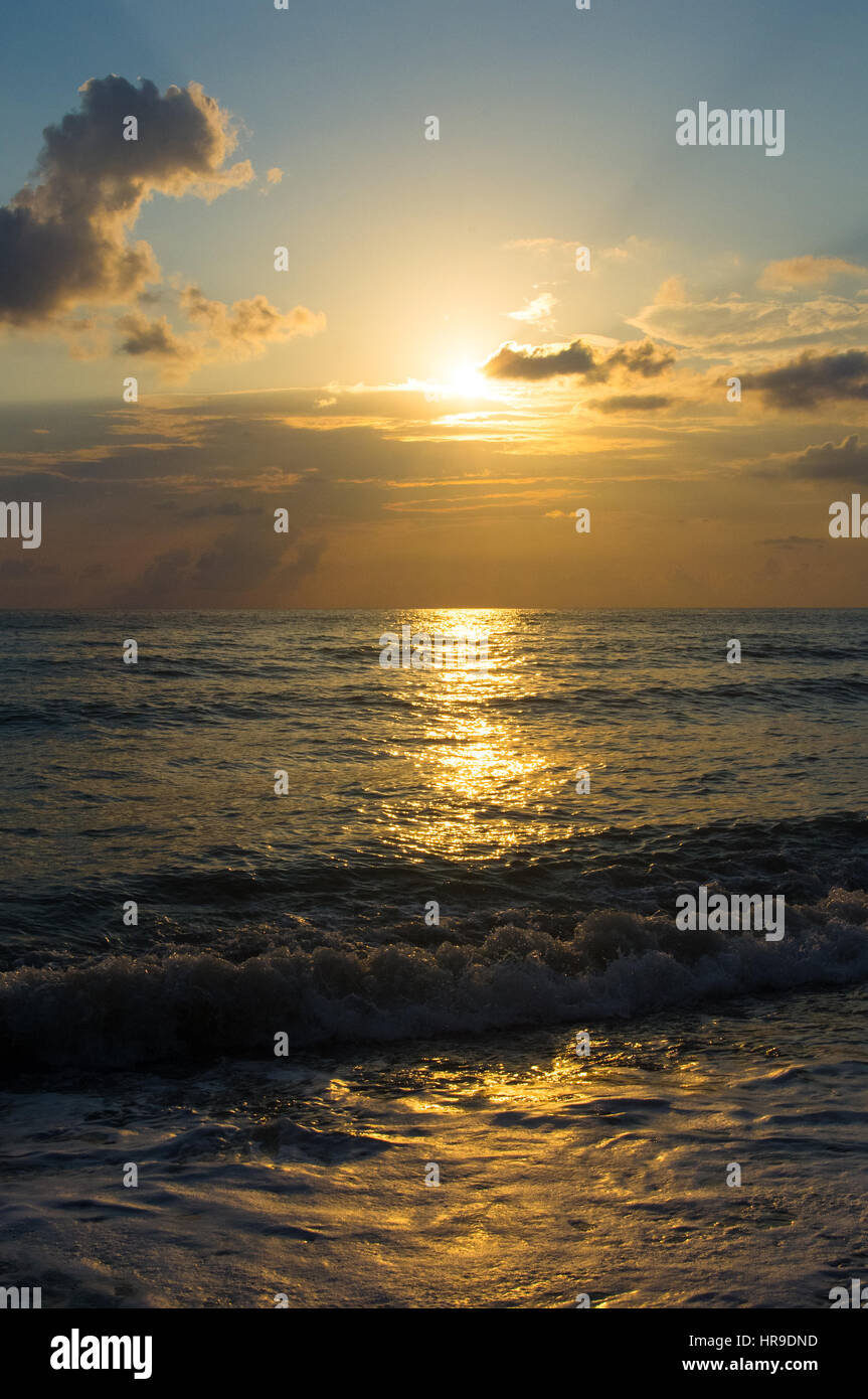 solar path on the sea on a Sunset and yellow sky with clouds Stock ...