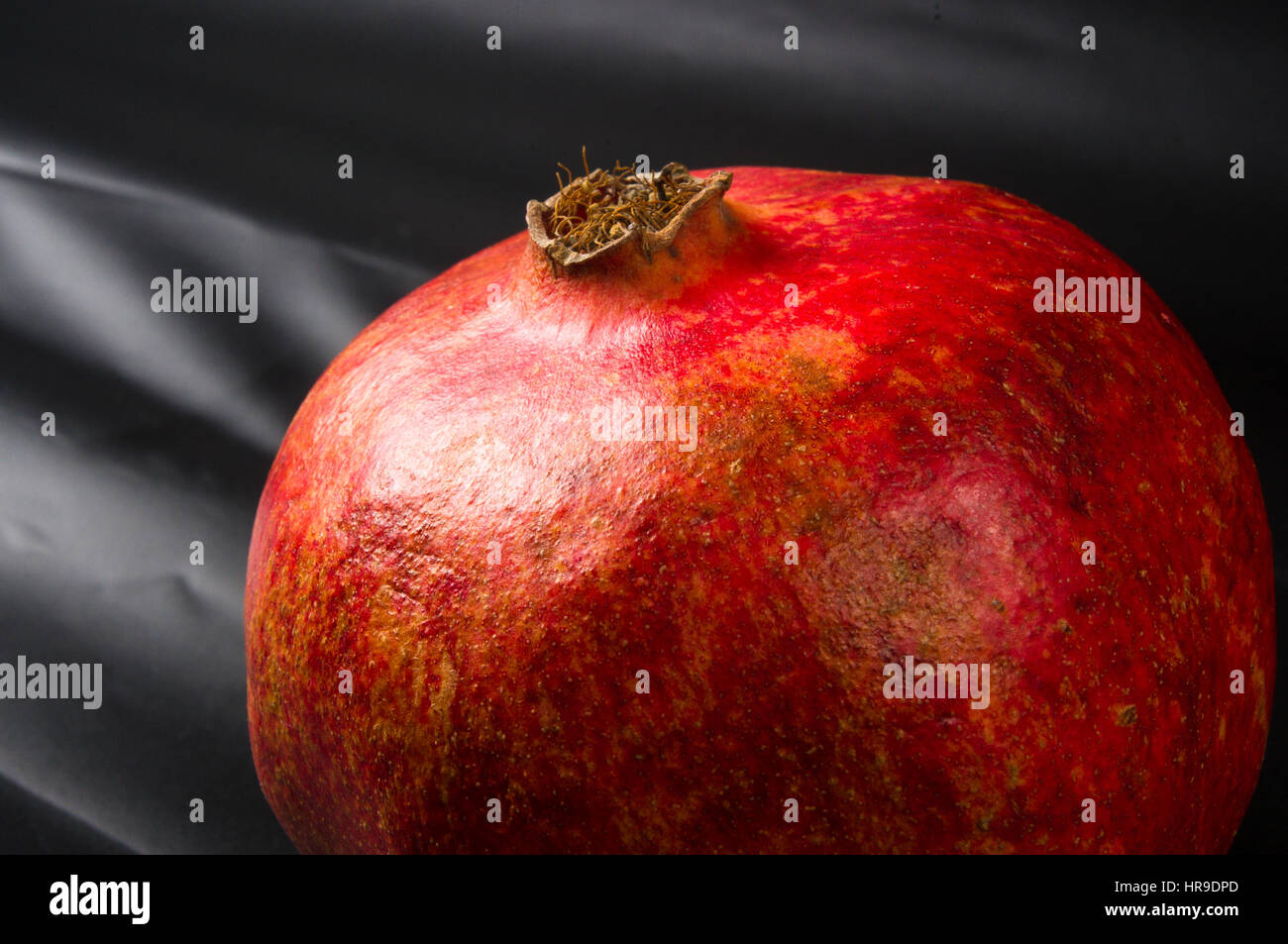 Big Pomegranate fruit on black background, closeup Stock Photo - Alamy