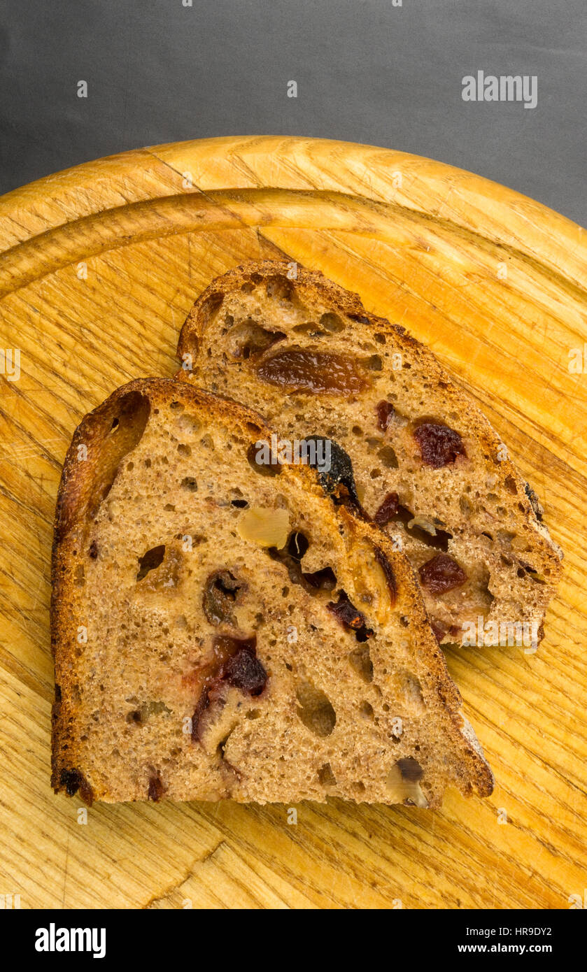 Slices of malt bread handmade with nuts, raisins and cranberries on ...