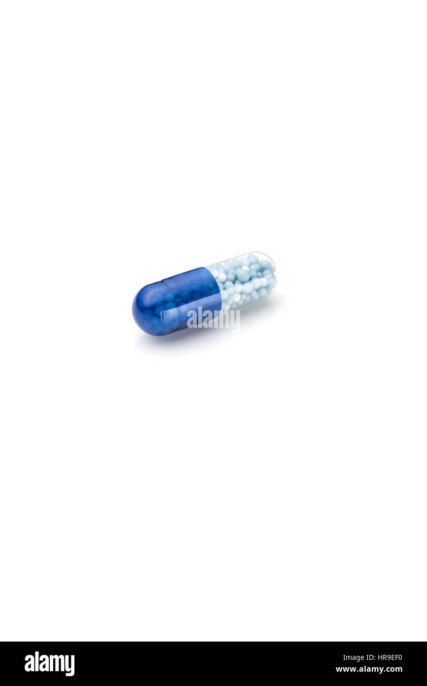 Blue capsule and pills on white background Stock Photo - Alamy