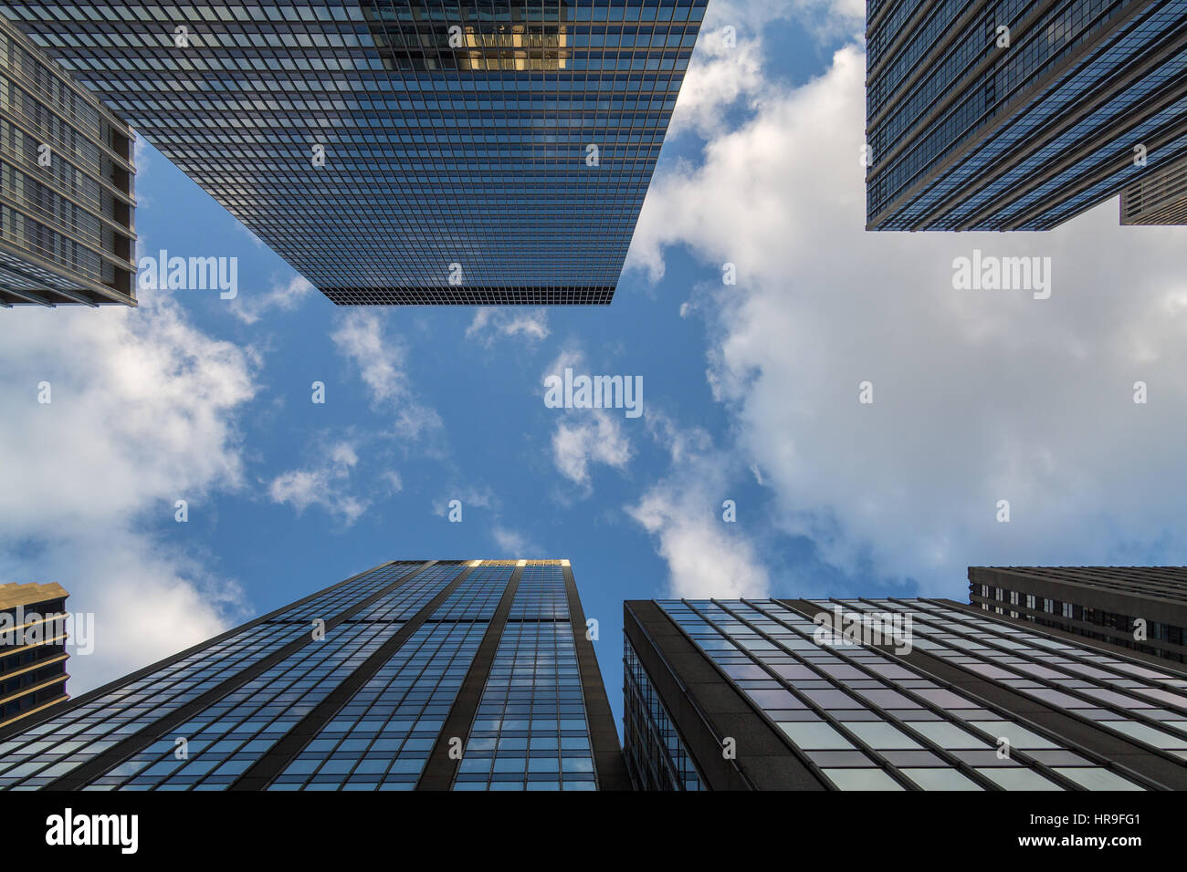Looking up between skyscrapers in midtown Manhattan Stock Photo - Alamy