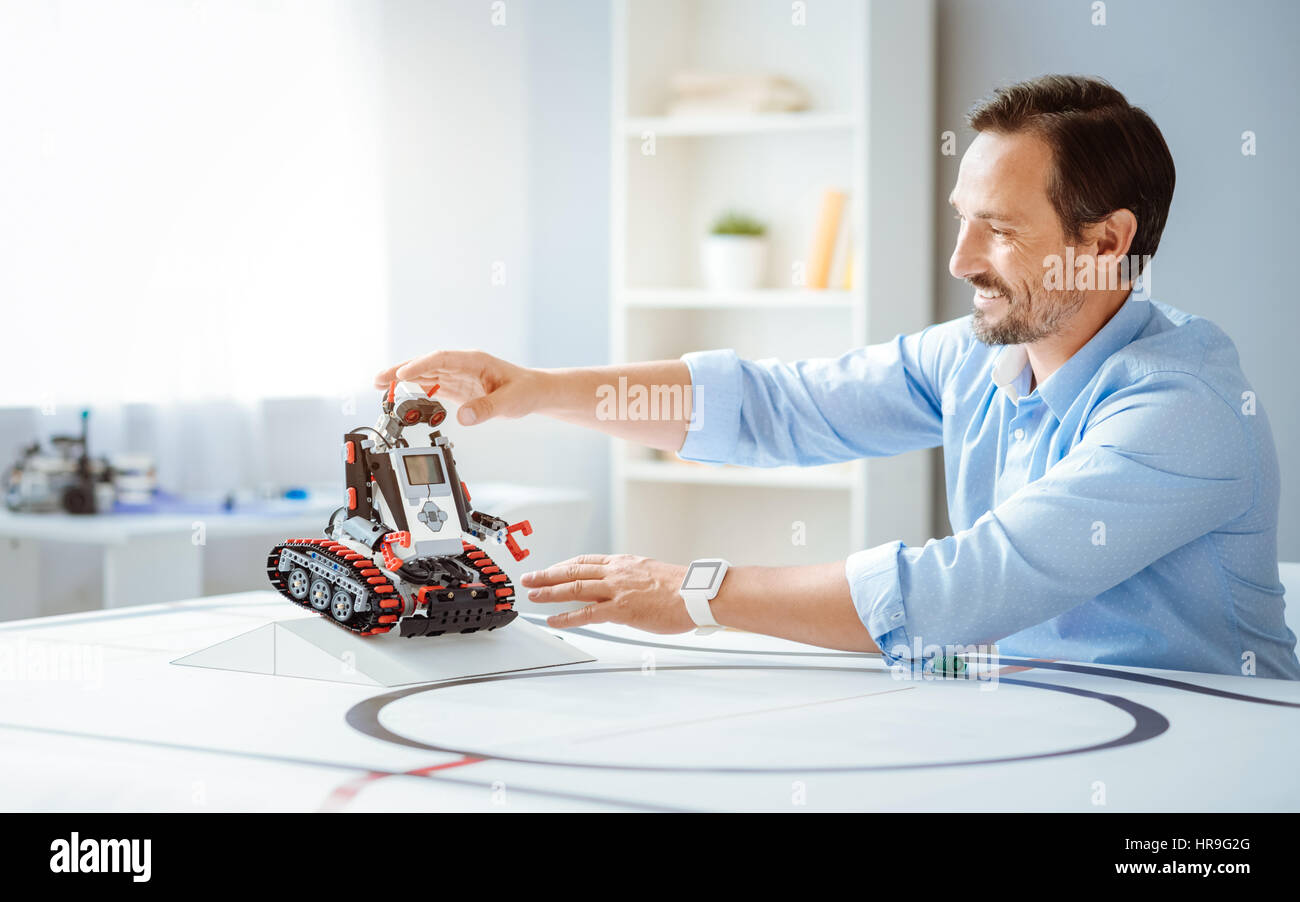 Positive professional engineer testing robot Stock Photo - Alamy