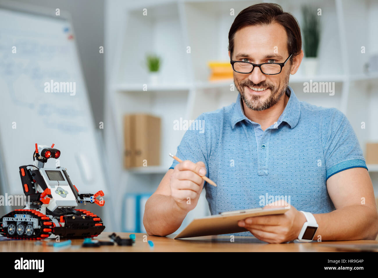 Positive engineer working in a lab Stock Photo - Alamy