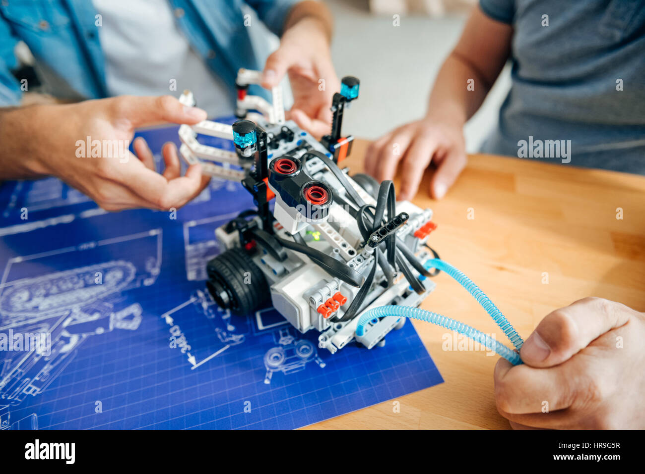 Professional engineers constructing the robot Stock Photo - Alamy