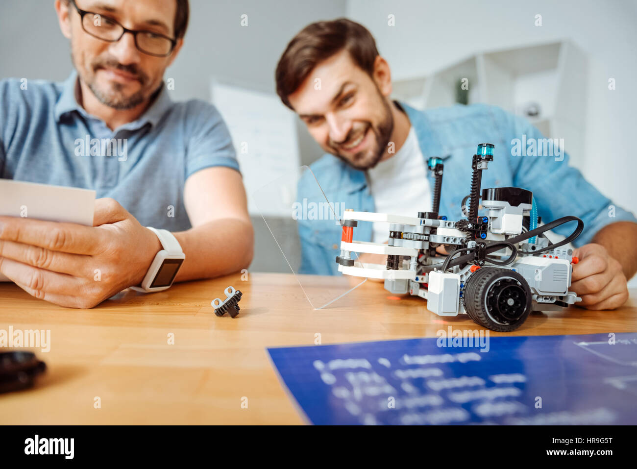 Positive engineers testing the robot Stock Photo - Alamy