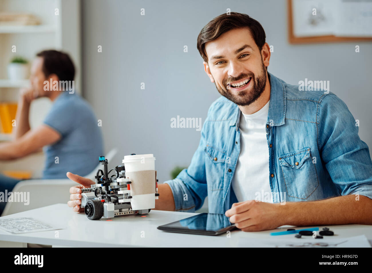 Positive professional engineer testing robot Stock Photo - Alamy