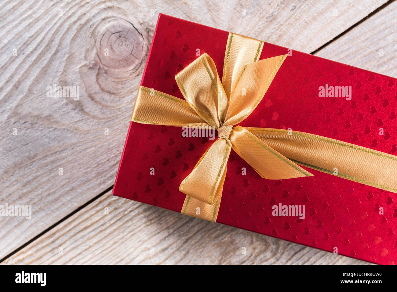 Red gift box with gold ribbon Stock Photo - Alamy