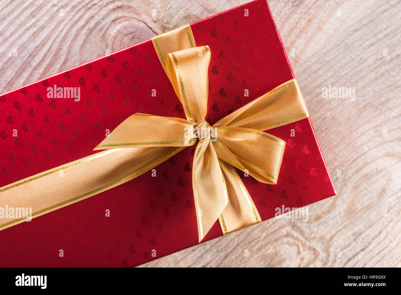 Red gift box with gold ribbon Stock Photo - Alamy