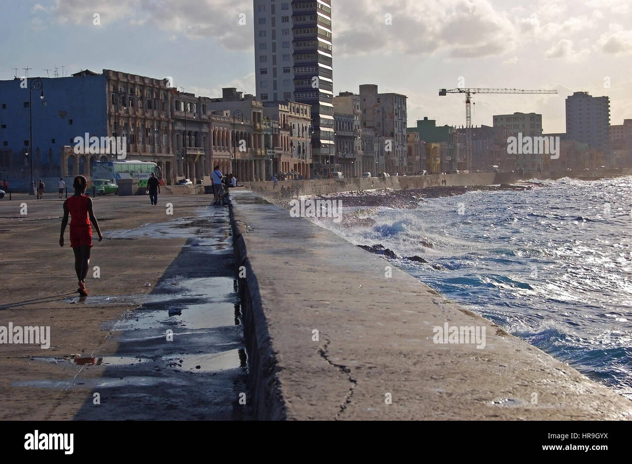 Young Girl in Red walking the Malecon Promenade, City of Havana, Cuba ...