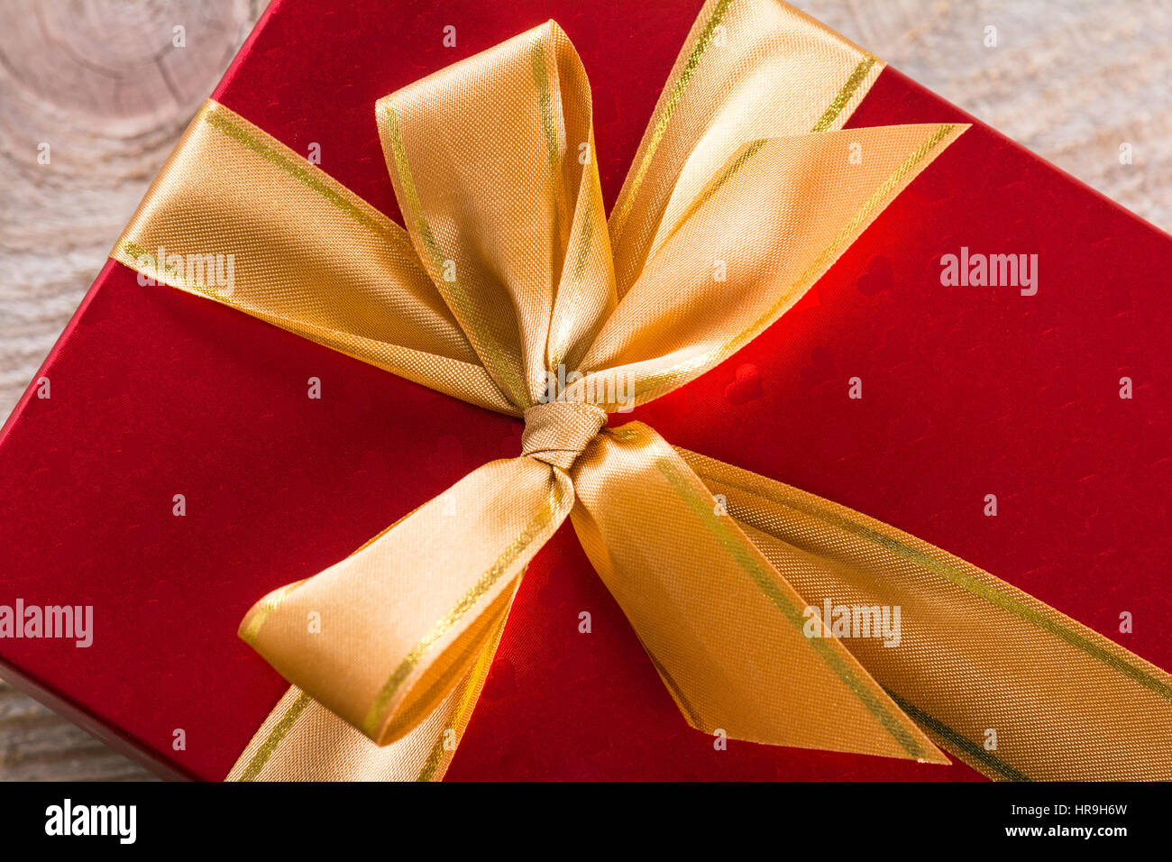 Red gift box with gold ribbon Stock Photo - Alamy
