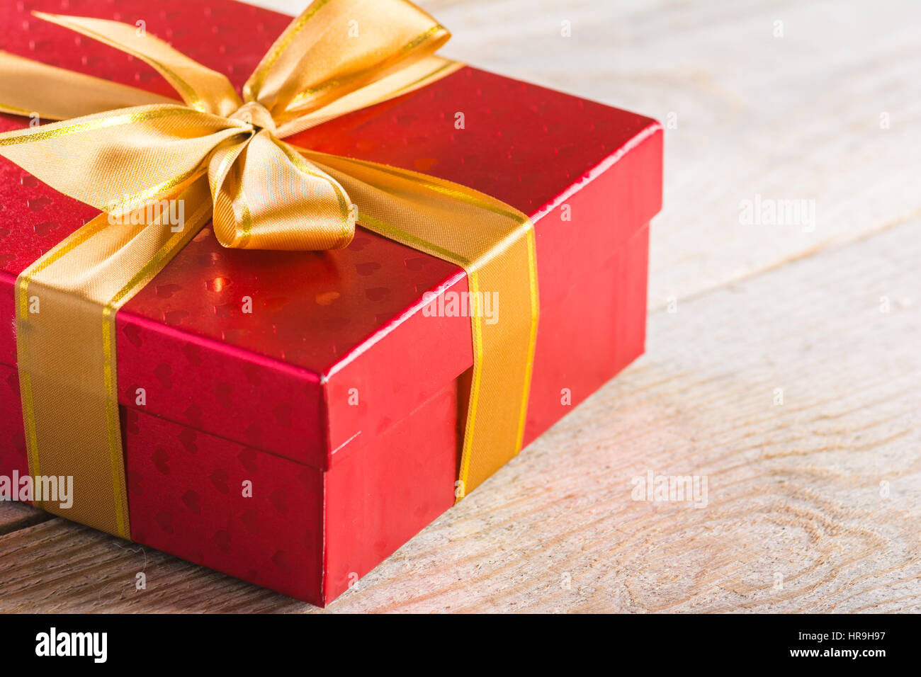 Red gift box with gold ribbon Stock Photo - Alamy
