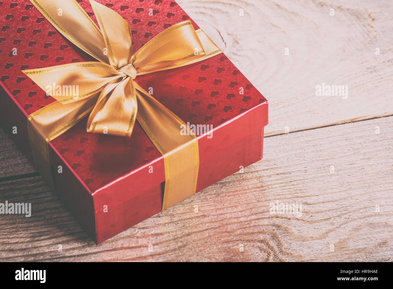 Red gift box with gold ribbon Stock Photo - Alamy