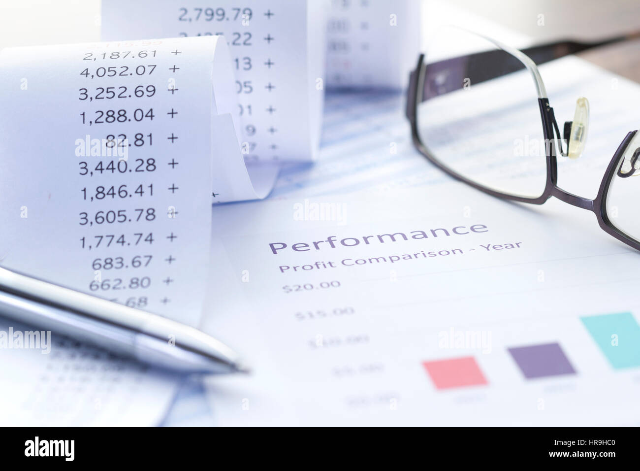 Business performance analysis with colorful bar graph and eyeglasses ...