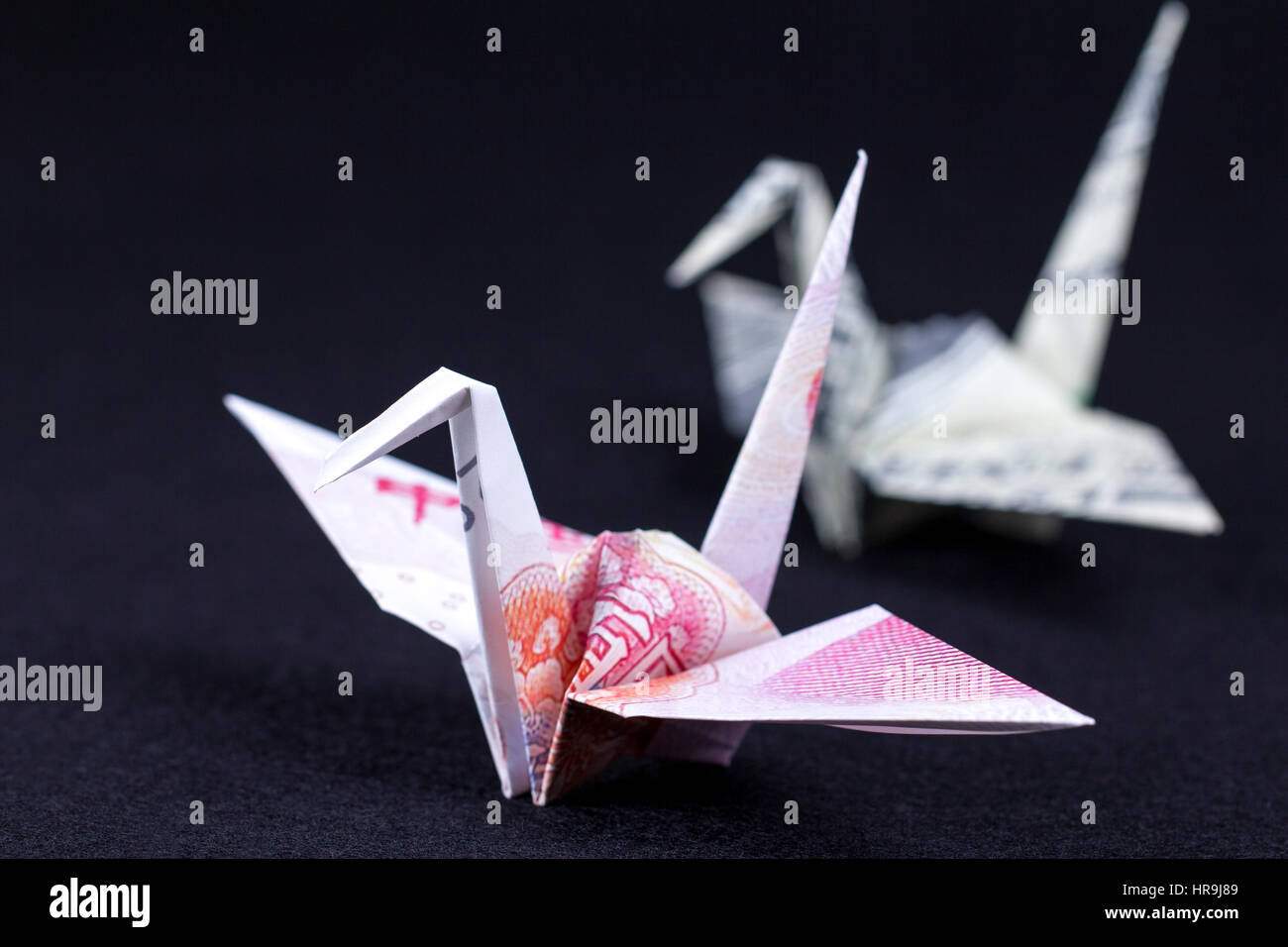 USD and CNY Bank Notes Origami on Black Stock Photo - Alamy
