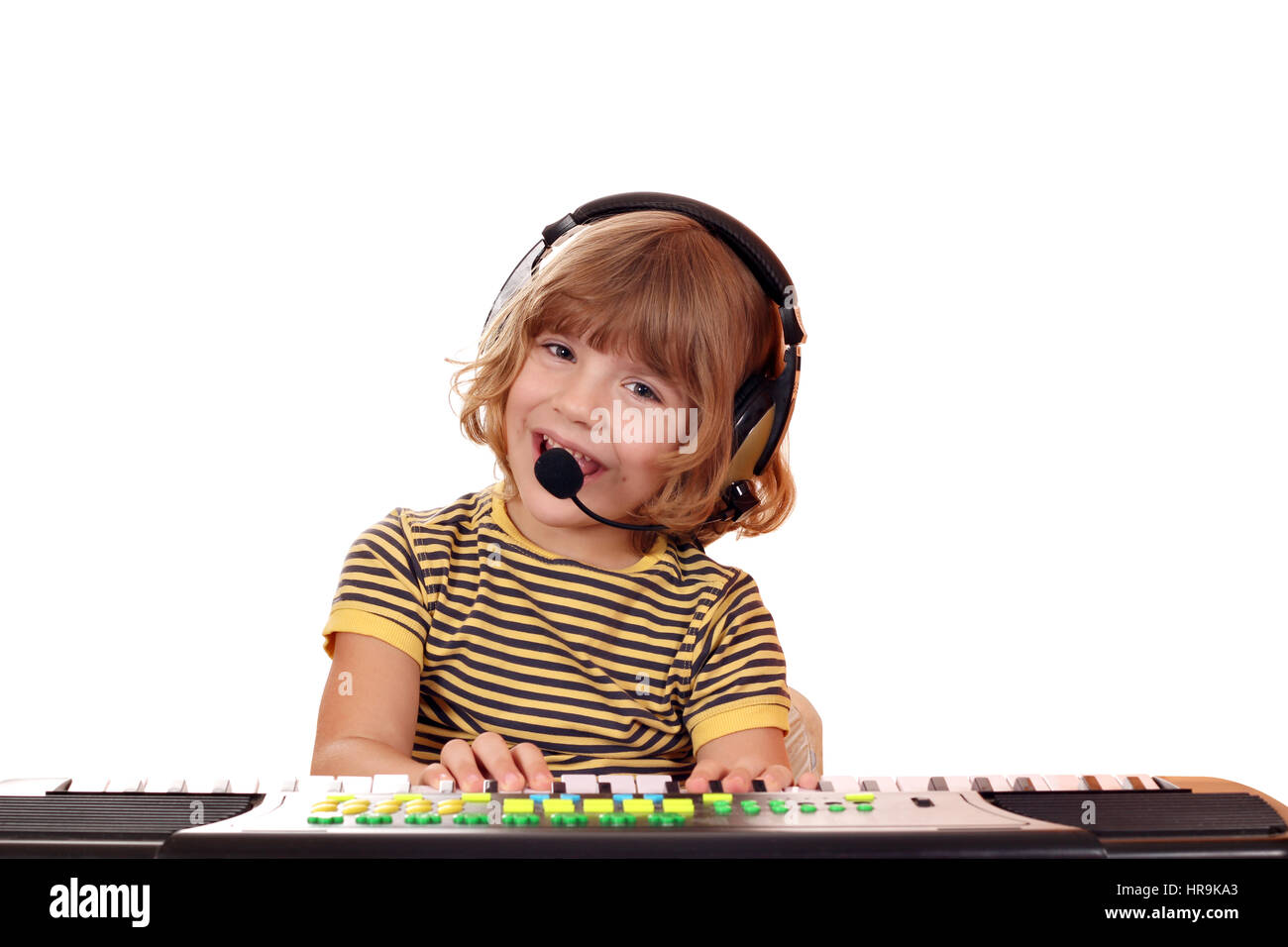 happy little girl sing and play keyboard Stock Photo - Alamy
