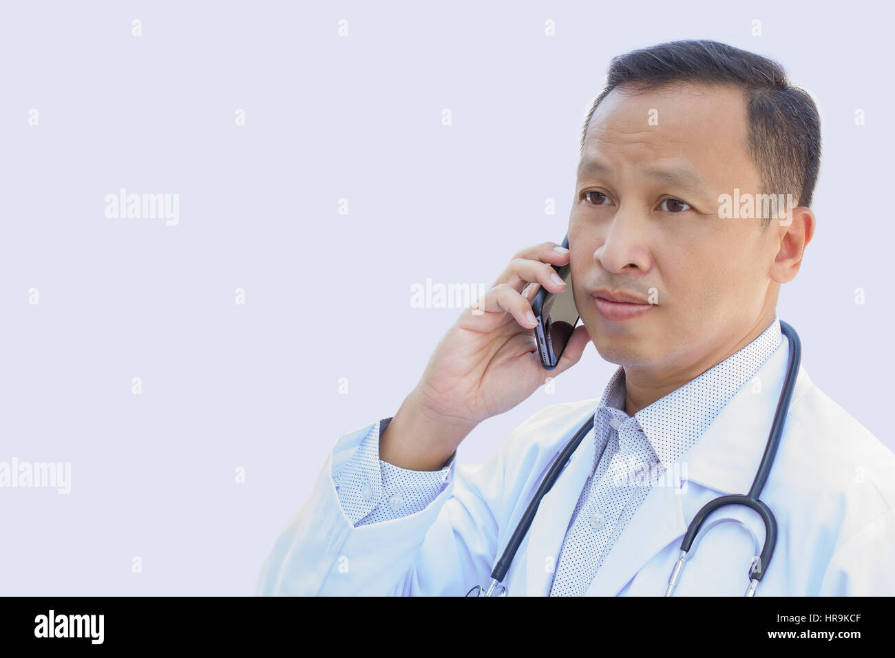 Doctor using mobile phone isolated on white background Stock Photo - Alamy