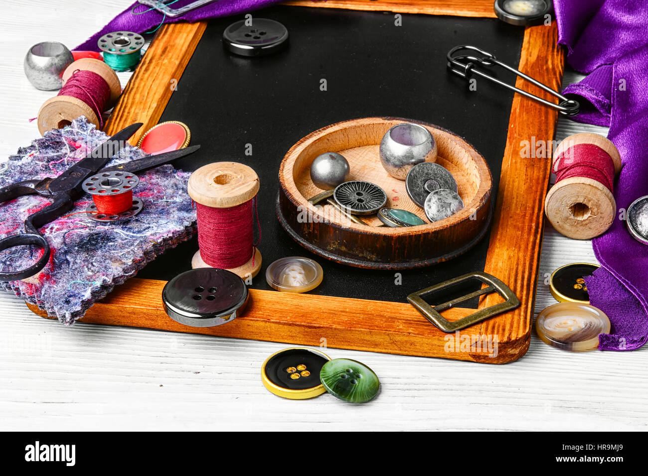 button and sewing thread on the chalk board for drawing Stock Photo - Alamy