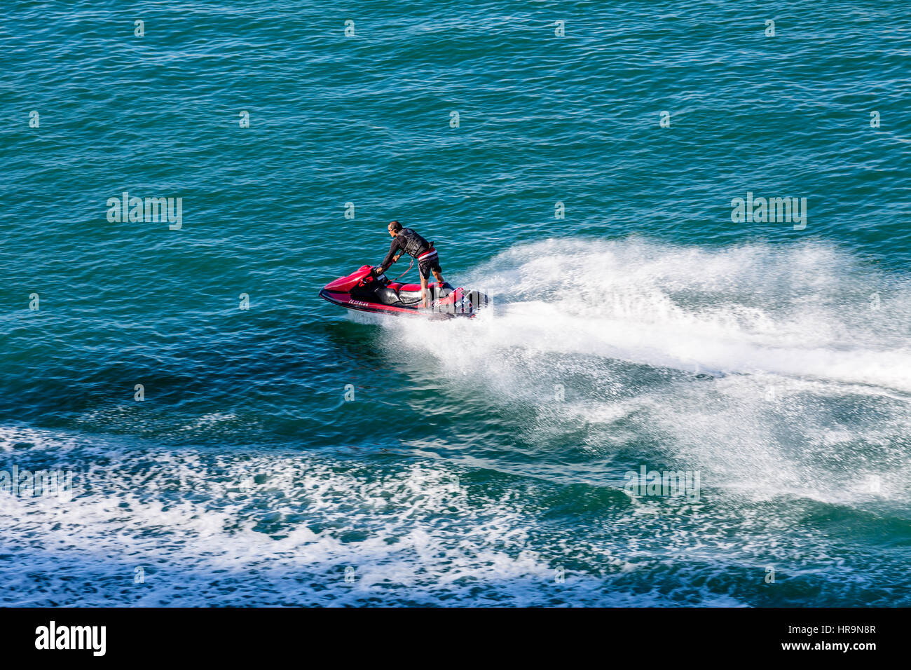 Man Standing on Red Jet Ski Stock Photo - Alamy