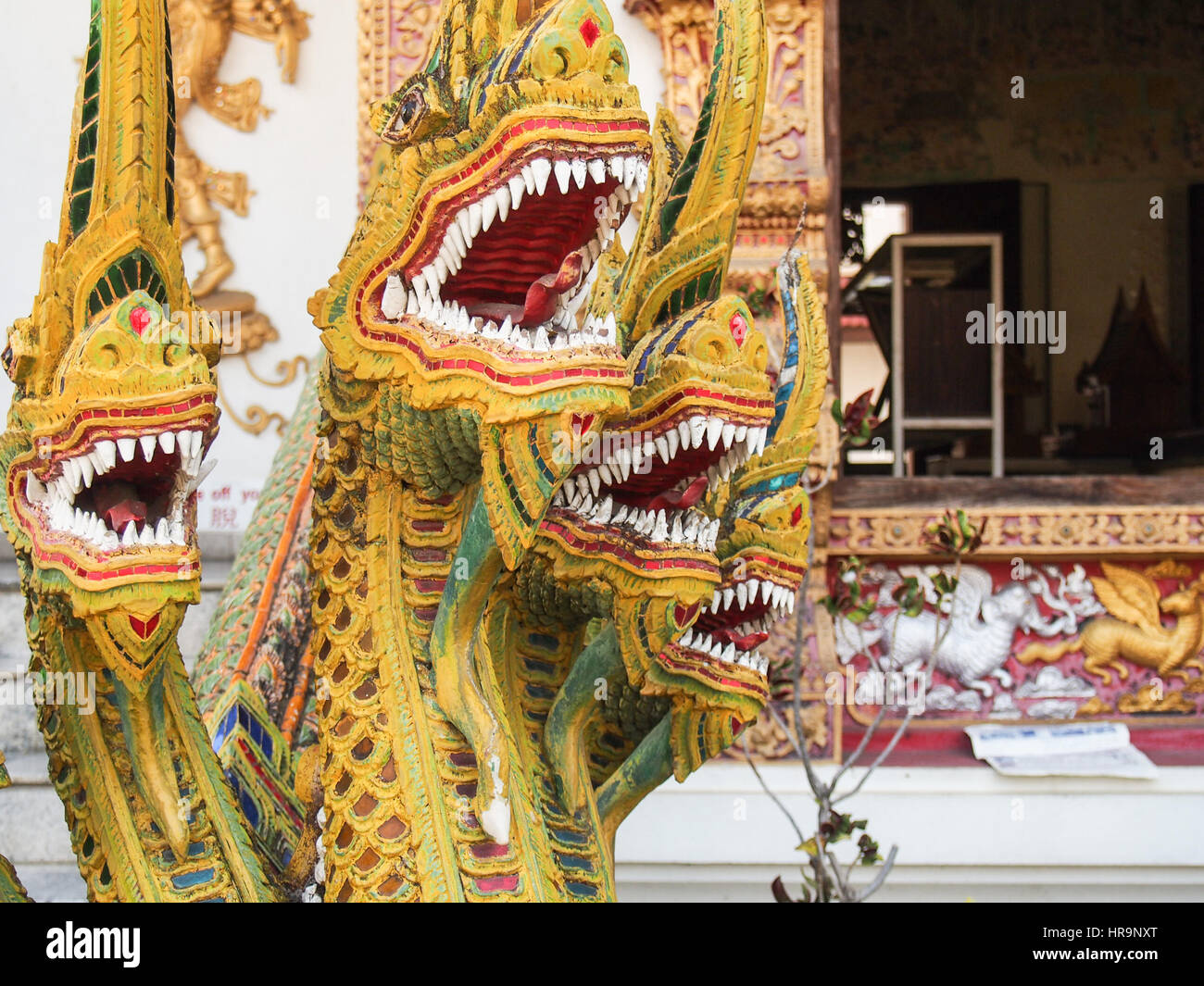 Bright yellow multi-headed dragon sculpture at a temple in Chiang Mai ...