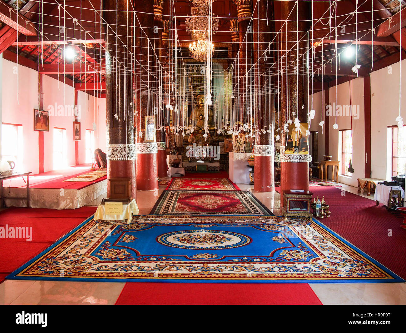 The interior of a temple in Chiang Mai Thailand is decorated with red ...