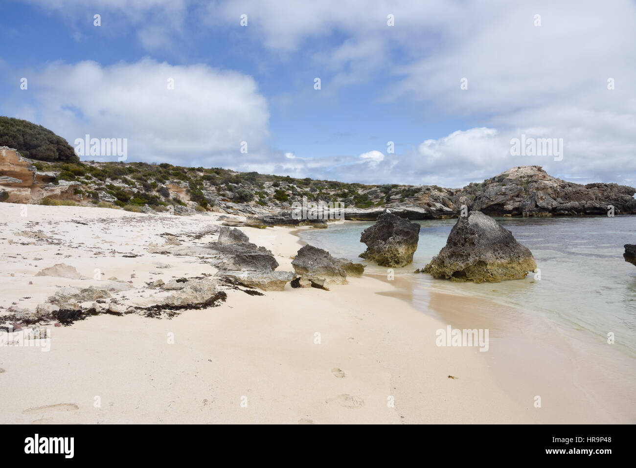 Secluded beach with limestone rock formations and calm Indian Ocean ...