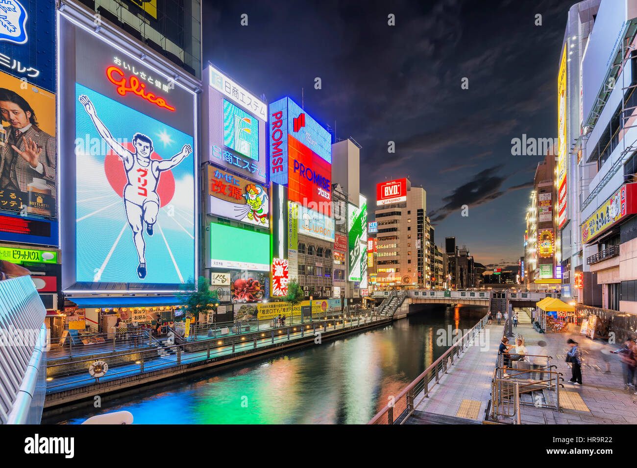 At night, Dotonbori–dori is ablaze with the neon lights of large ...