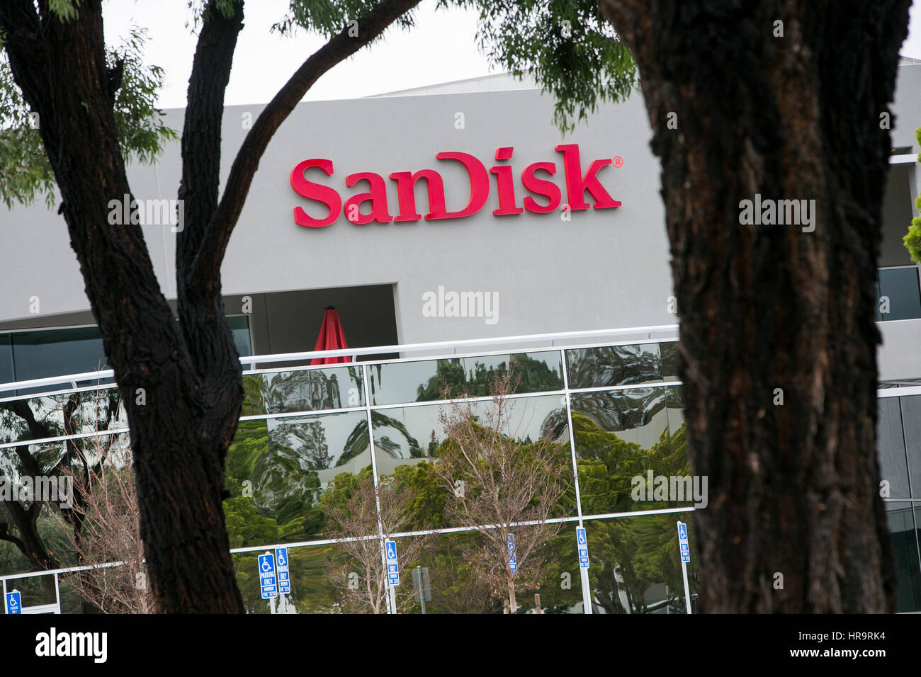 A logo sign outside of a facility occupied by SanDisk in San Jose ...