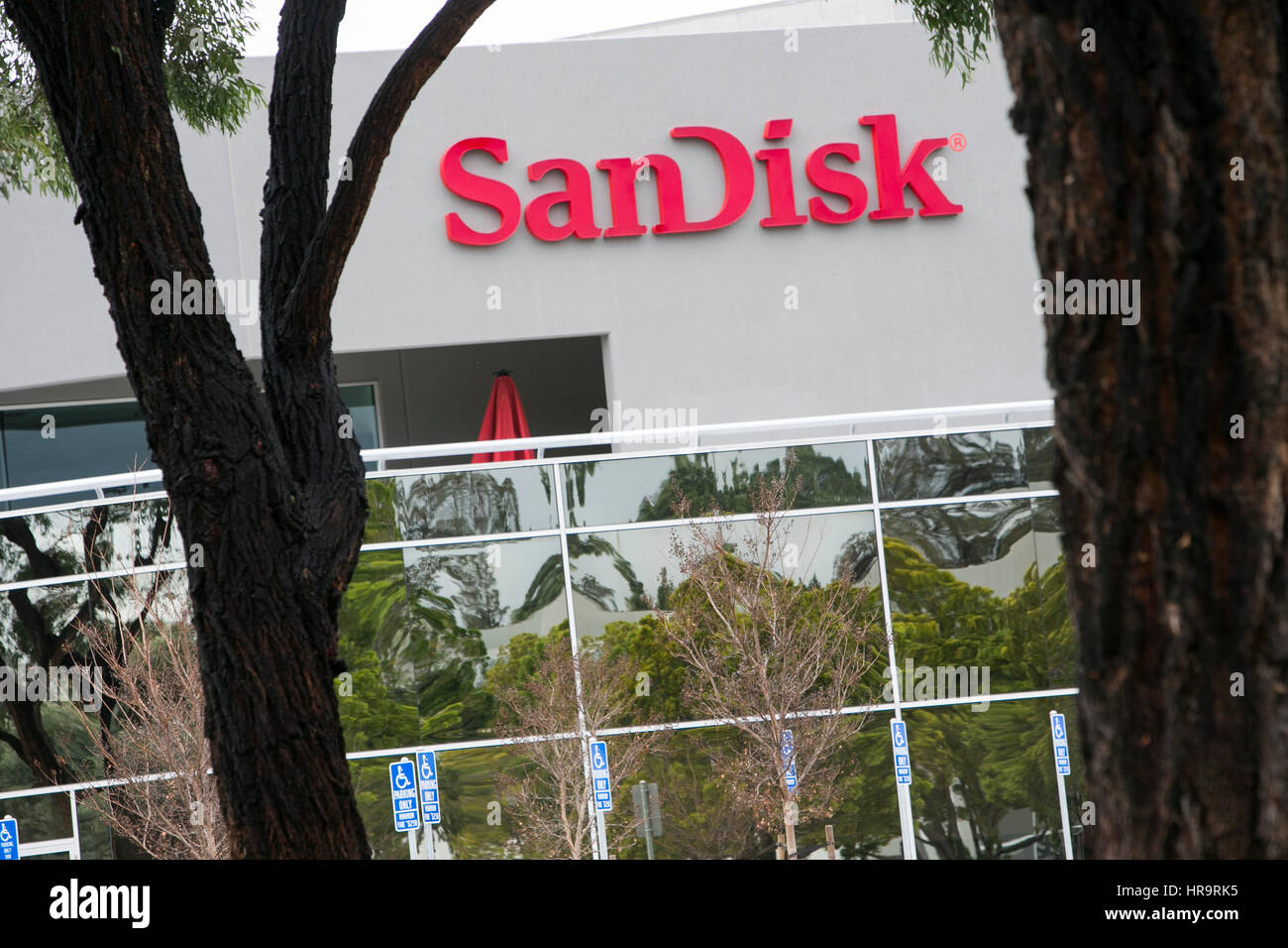 A logo sign outside of a facility occupied by SanDisk in San Jose ...