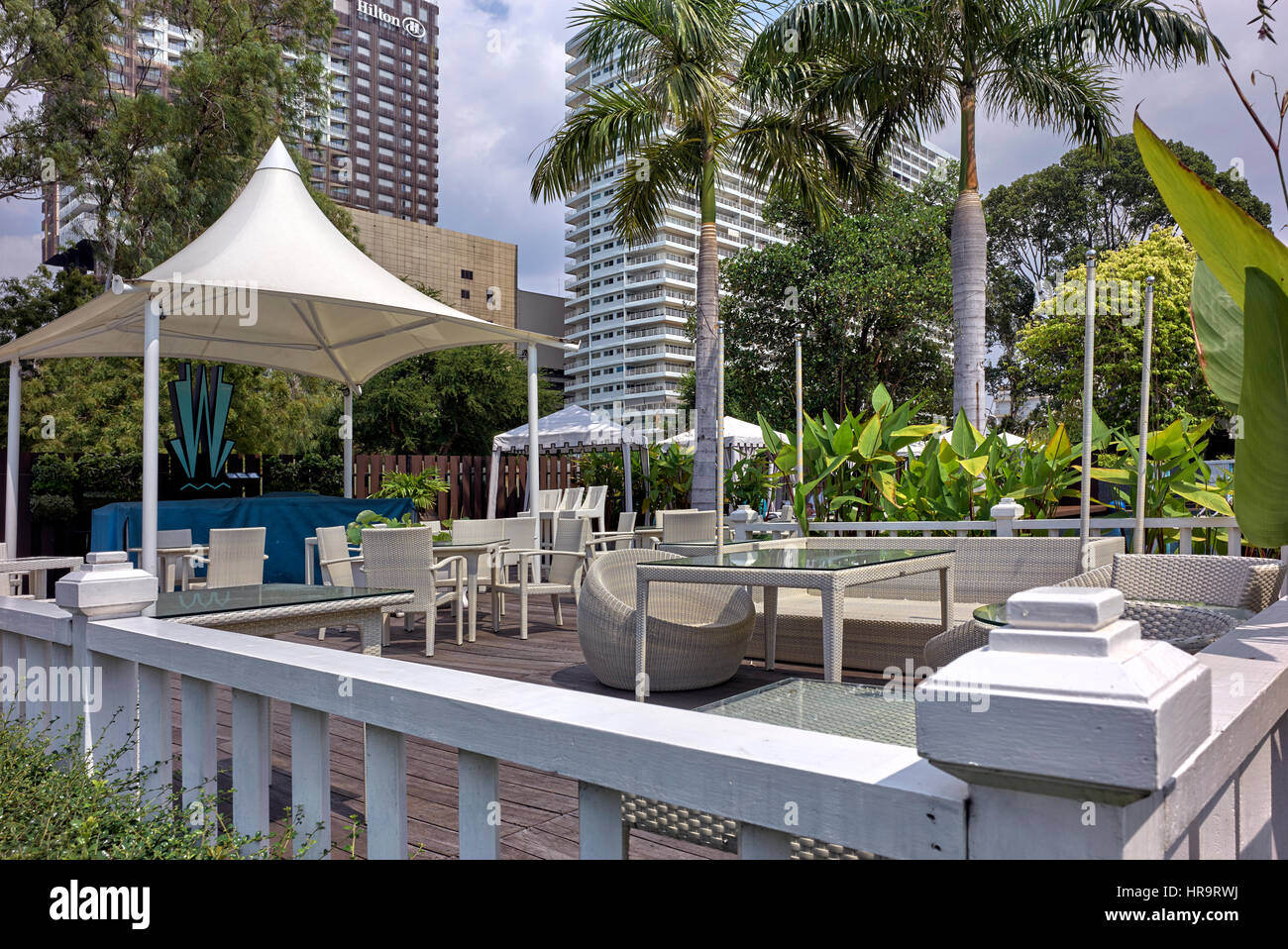 Restaurant outside dining terrace area with white wicker tables and ...