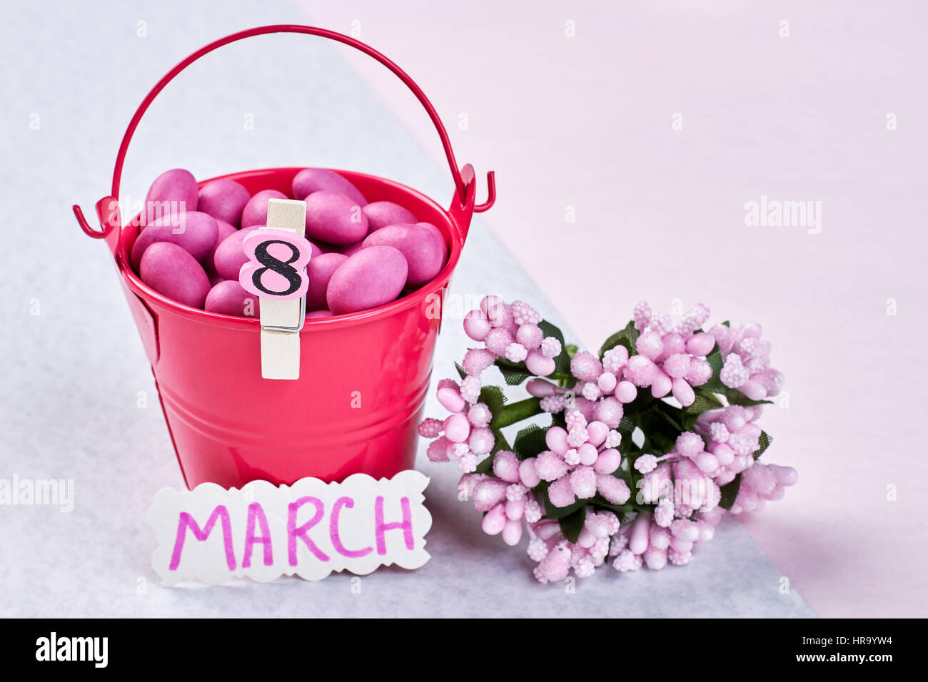 Bucket with sweets and flowers Stock Photo - Alamy