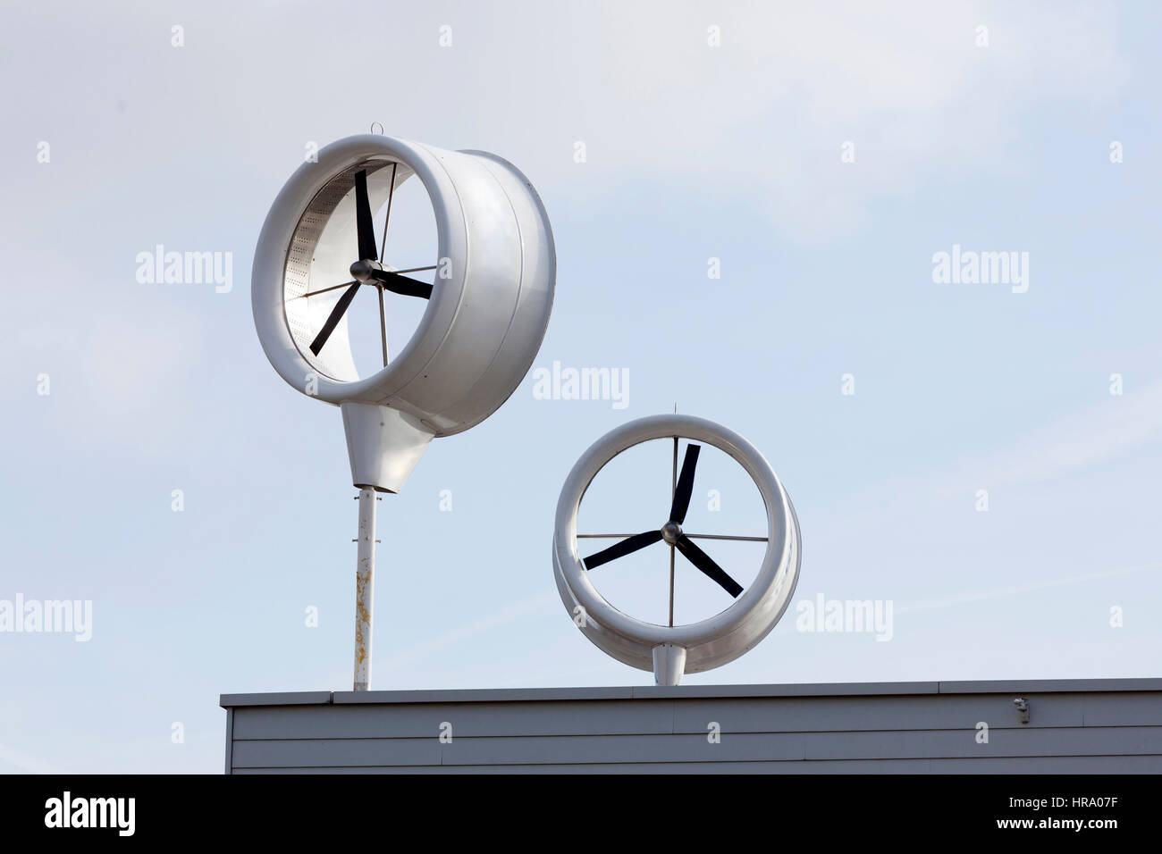 urban windmill on roof of new building in the netherlands and blue sky ...