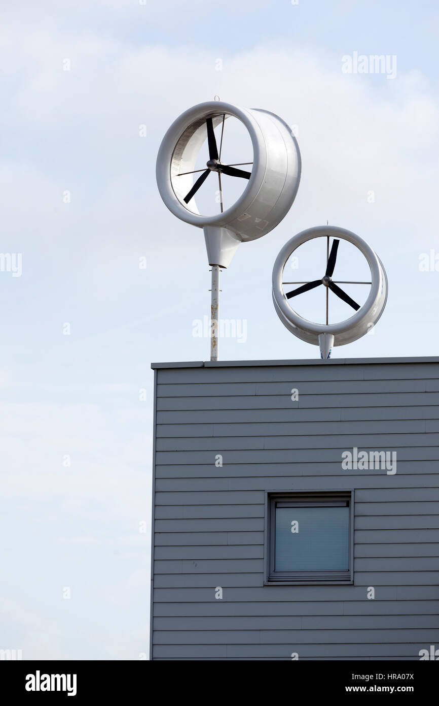 urban windmill on roof of new building in the netherlands and blue sky ...
