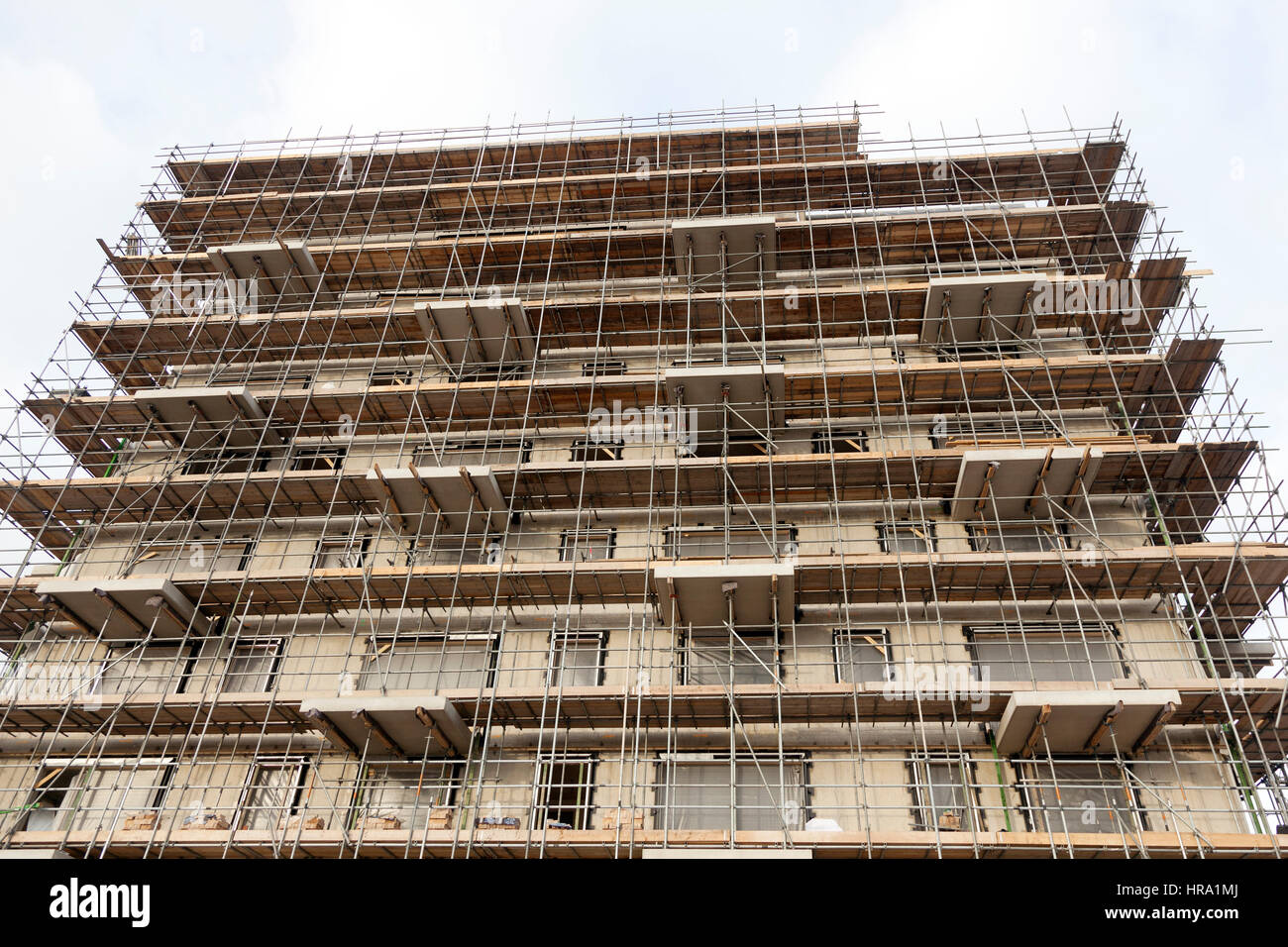 looking up to scaffolding on building site of new apartment building ...