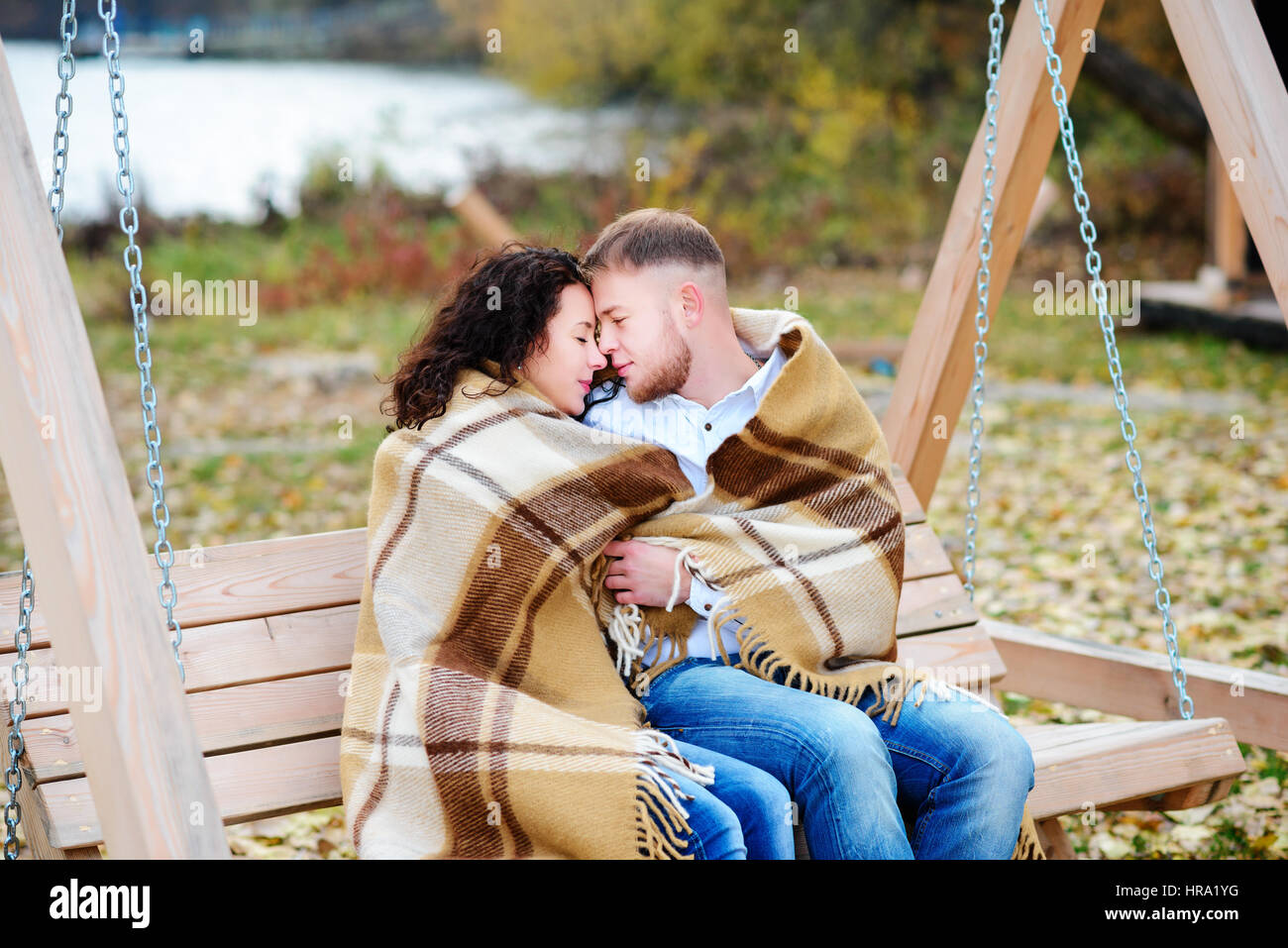 Couple sitting on swings hi-res stock photography and images - Alamy