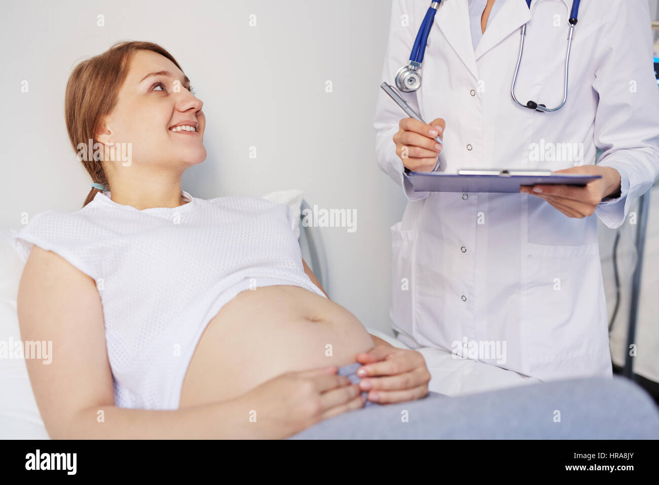 Close-up view of pregnant woman lying in clinic on check-up, getting ...