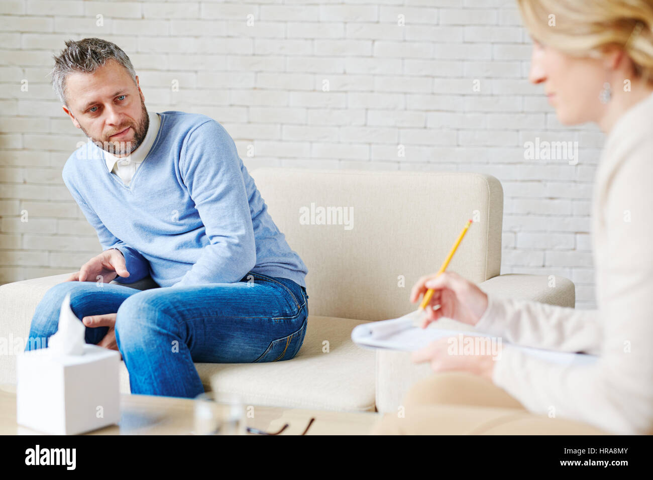 Portrait of bearded middle-aged patient sitting on comfortable armchair ...
