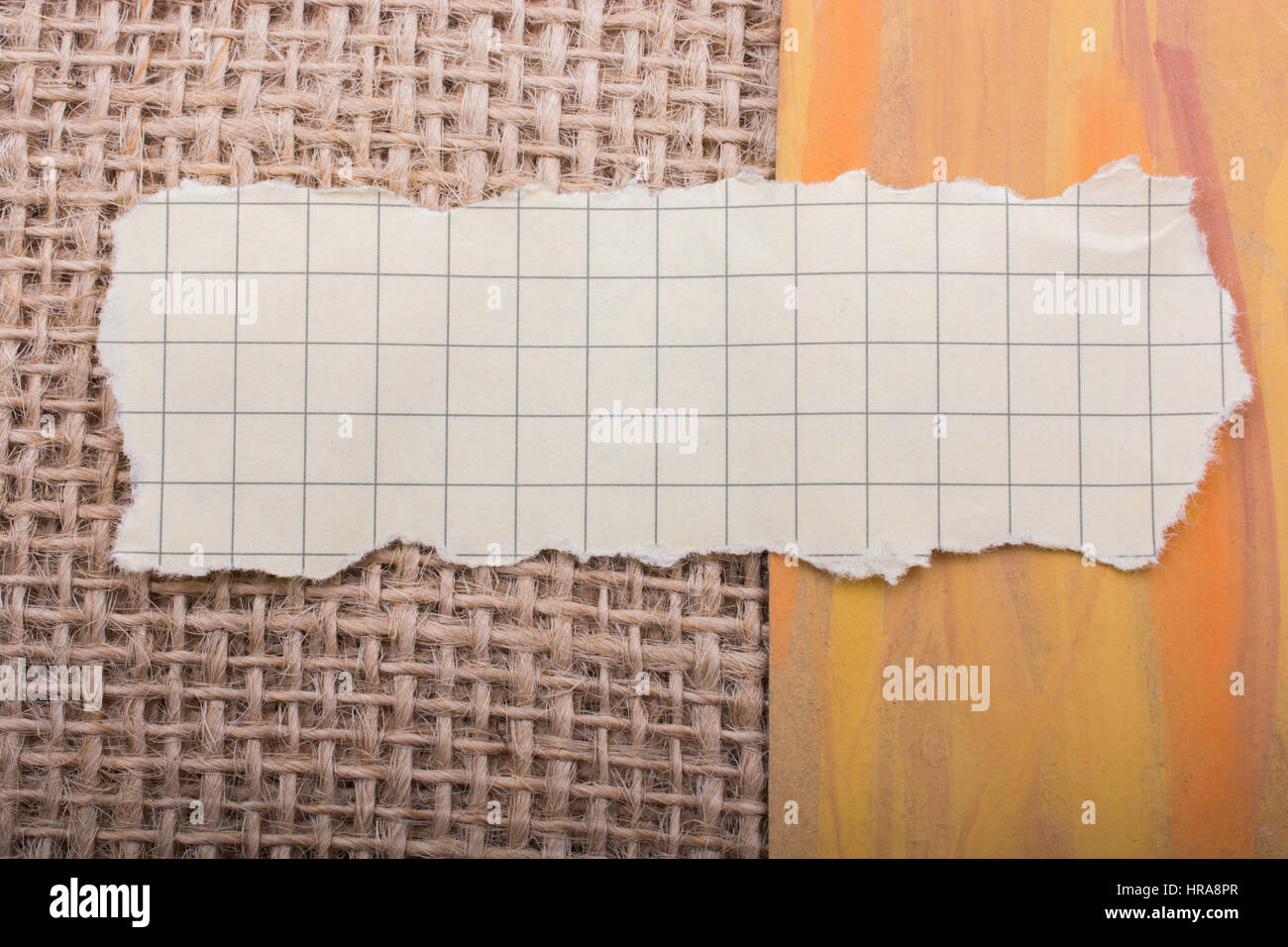 Piece of torn paper placed on a linen canvas Stock Photo - Alamy