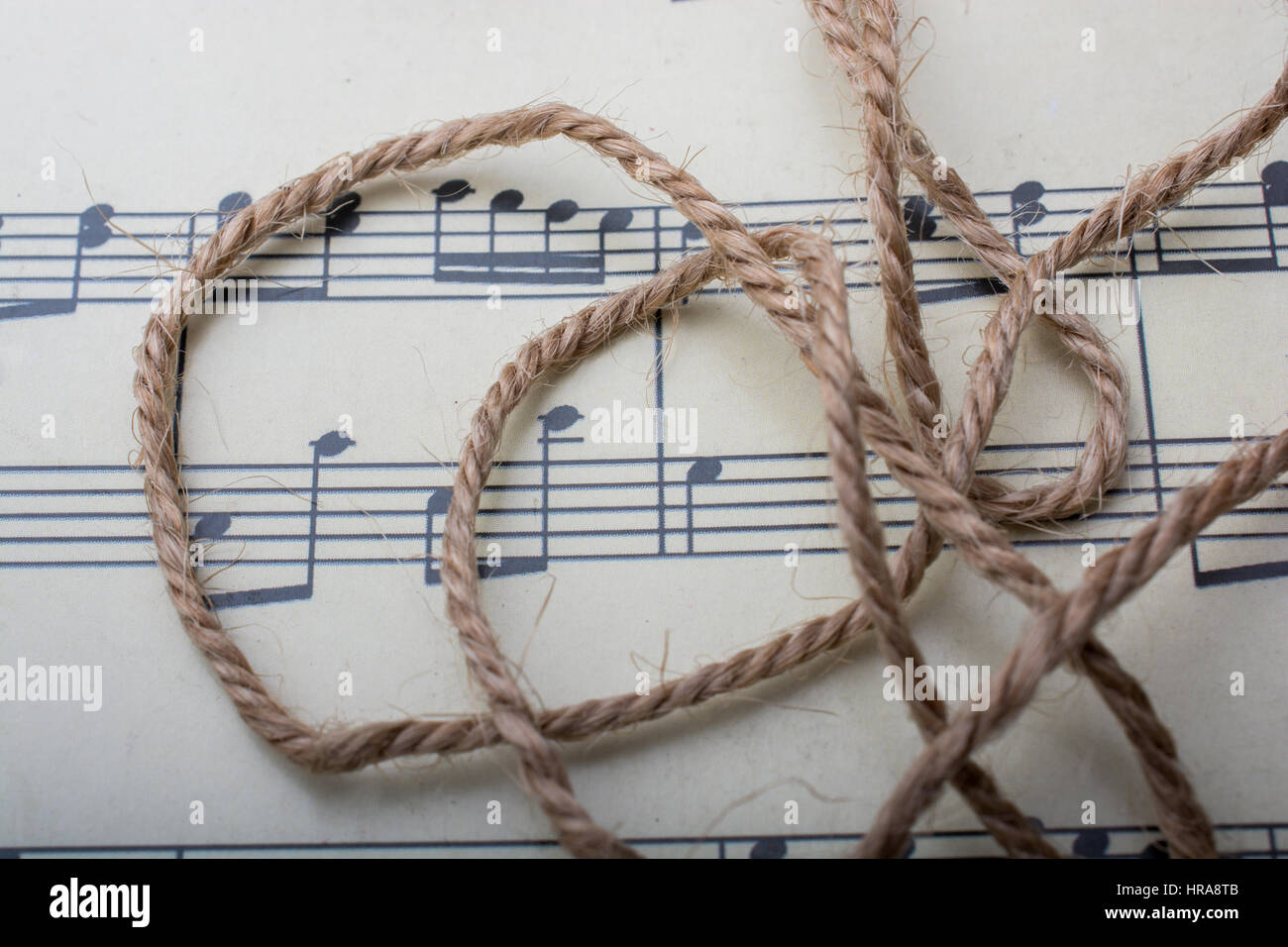 linen thread is placed on paper with musical notes Stock Photo - Alamy