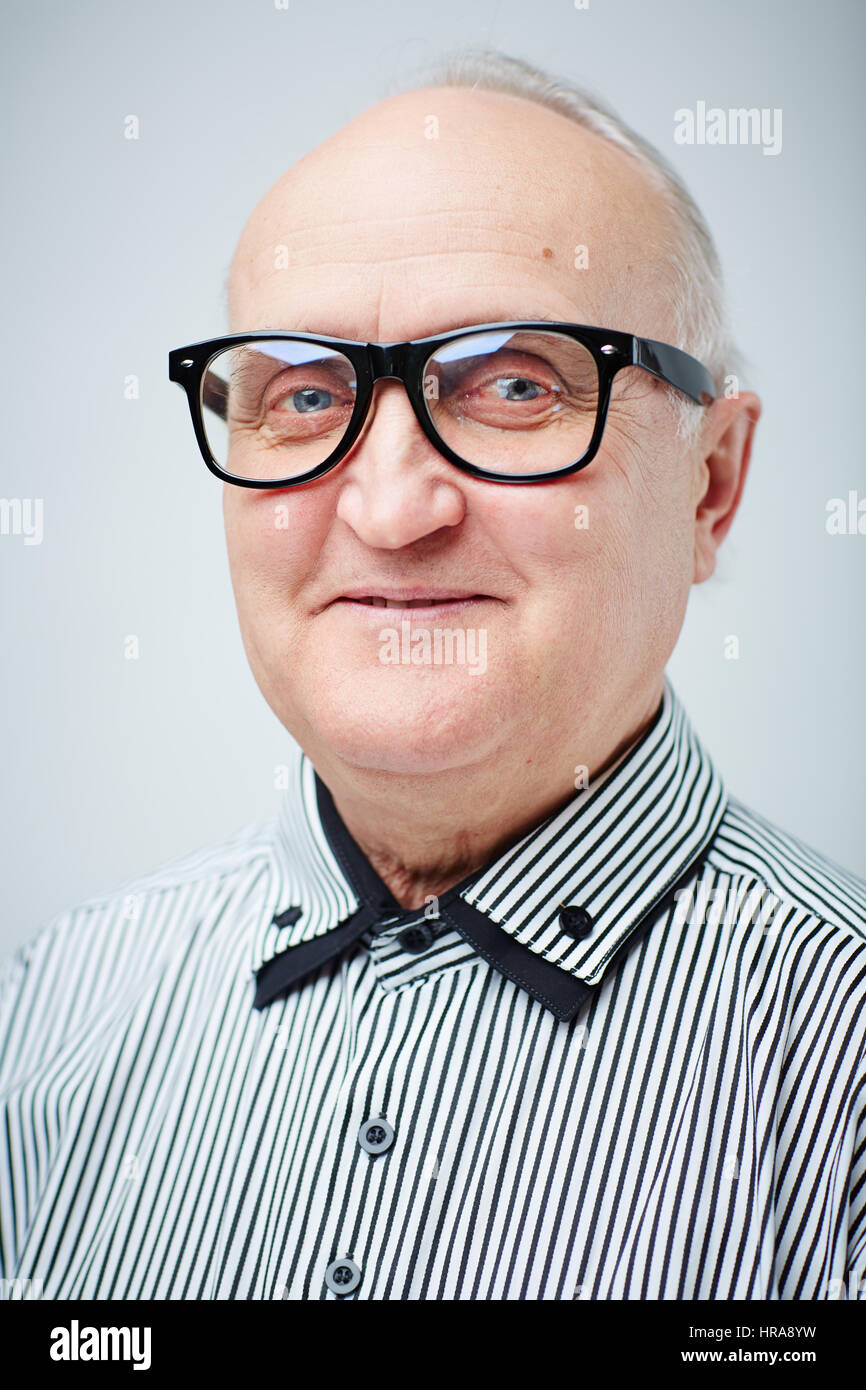 Close-up portrait of charming old gentleman in striped shirt and ...