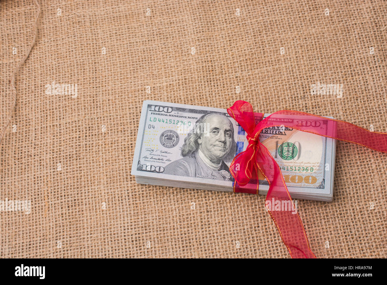 Banknote bundle of US dollar tied with colorful a ribbon Stock Photo ...