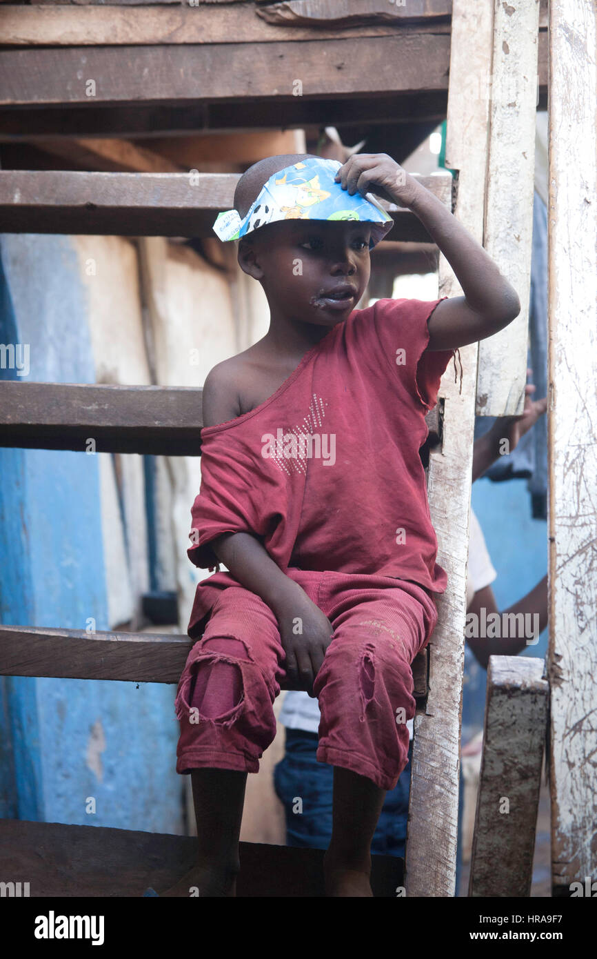 Young child sitting on the stairs of an orphanage in Kibera slums ...
